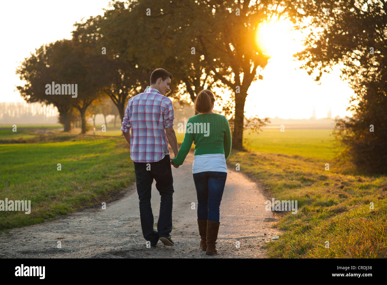 Young couple taking a walk outdoors, in nature Stock Photo - Alamy