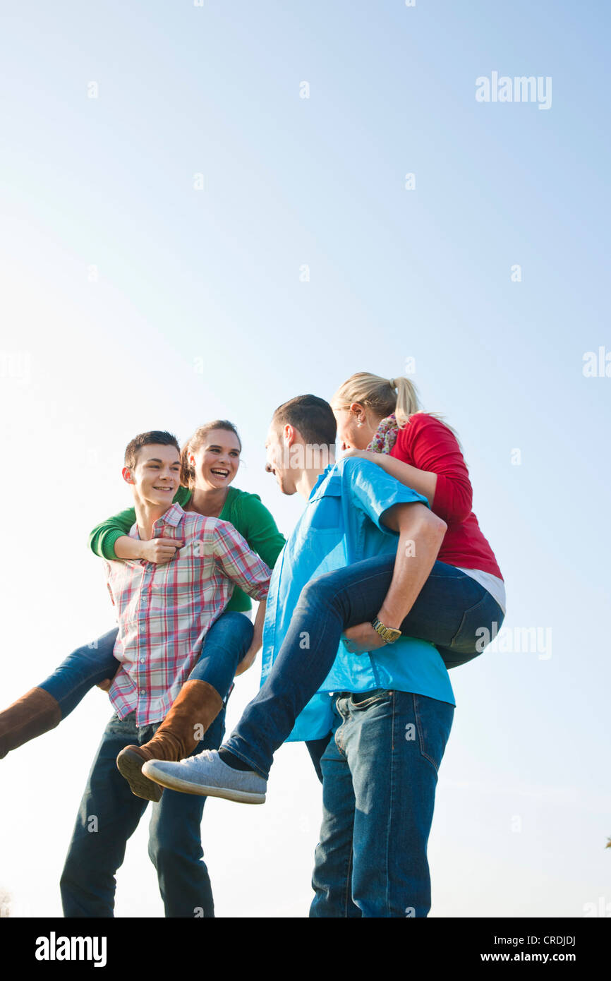 Young people, girls on piggyback Stock Photo - Alamy