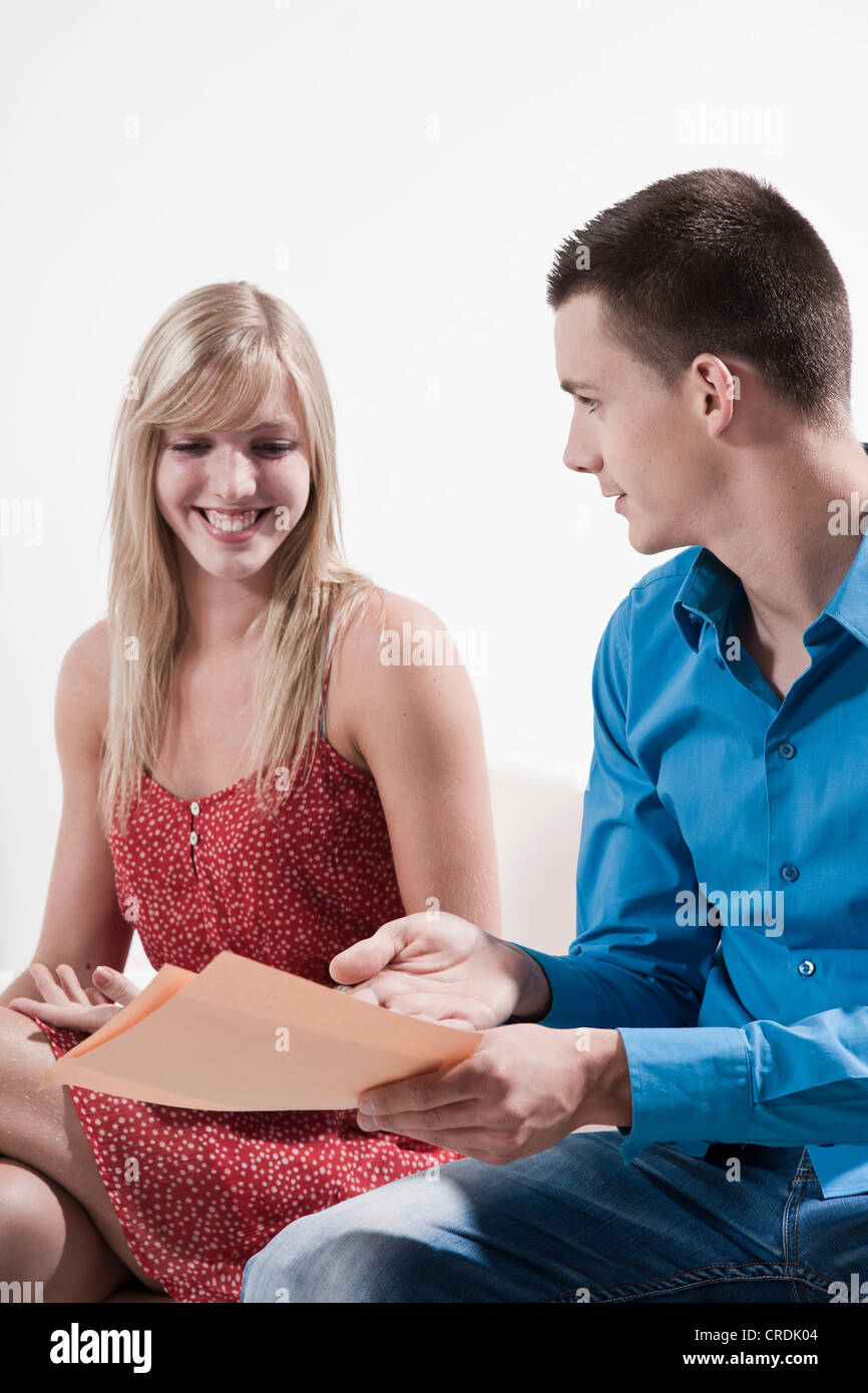 Happy young couple with a letter Stock Photo - Alamy