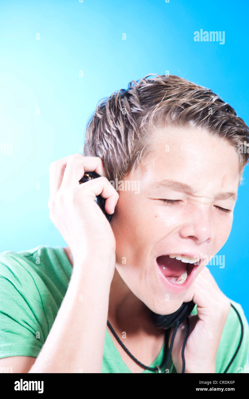 Boy listening to music Stock Photo - Alamy