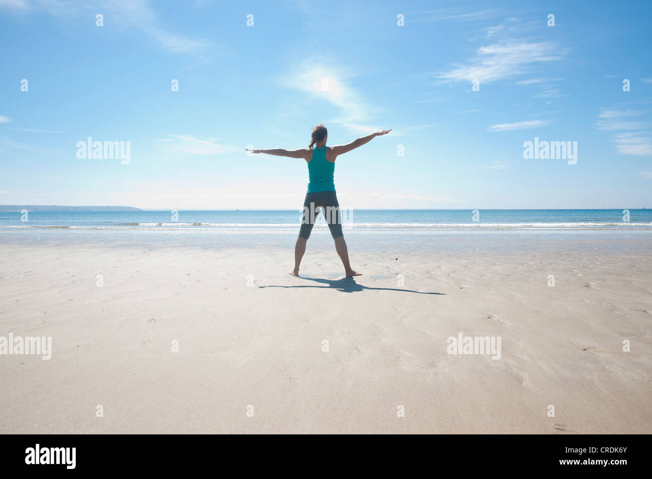 Woman doing stretching exercises, gymnastics on the beach, Camaret-sur ...
