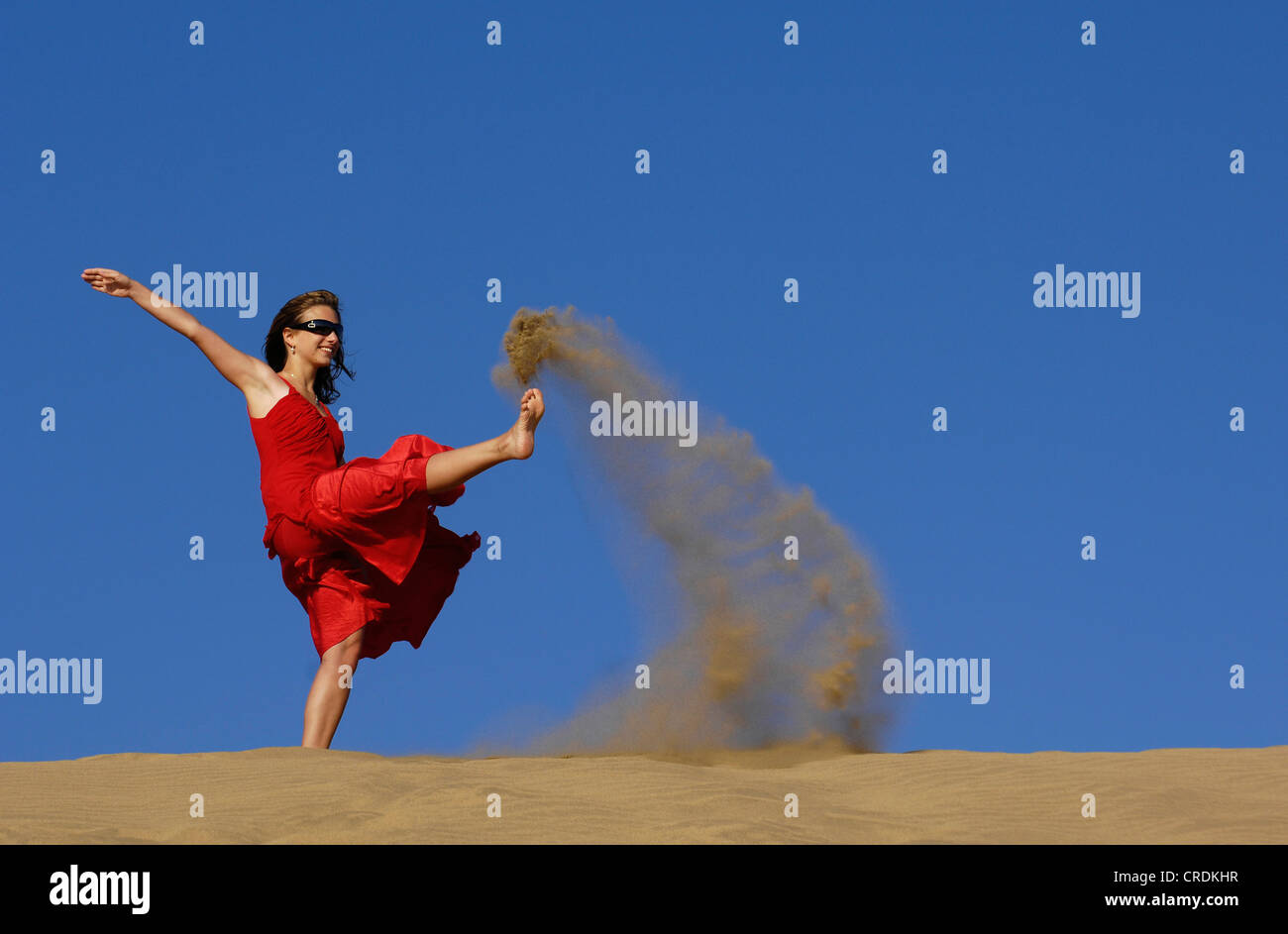 young woman kicking the sand Stock Photo - Alamy