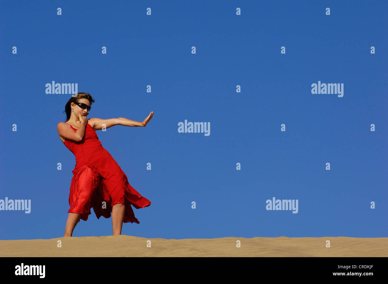 young woman standing in sand Stock Photo - Alamy