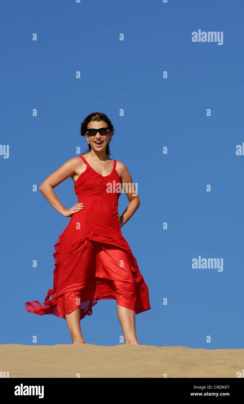 young woman standing in sand, with her hands on hips Stock Photo - Alamy