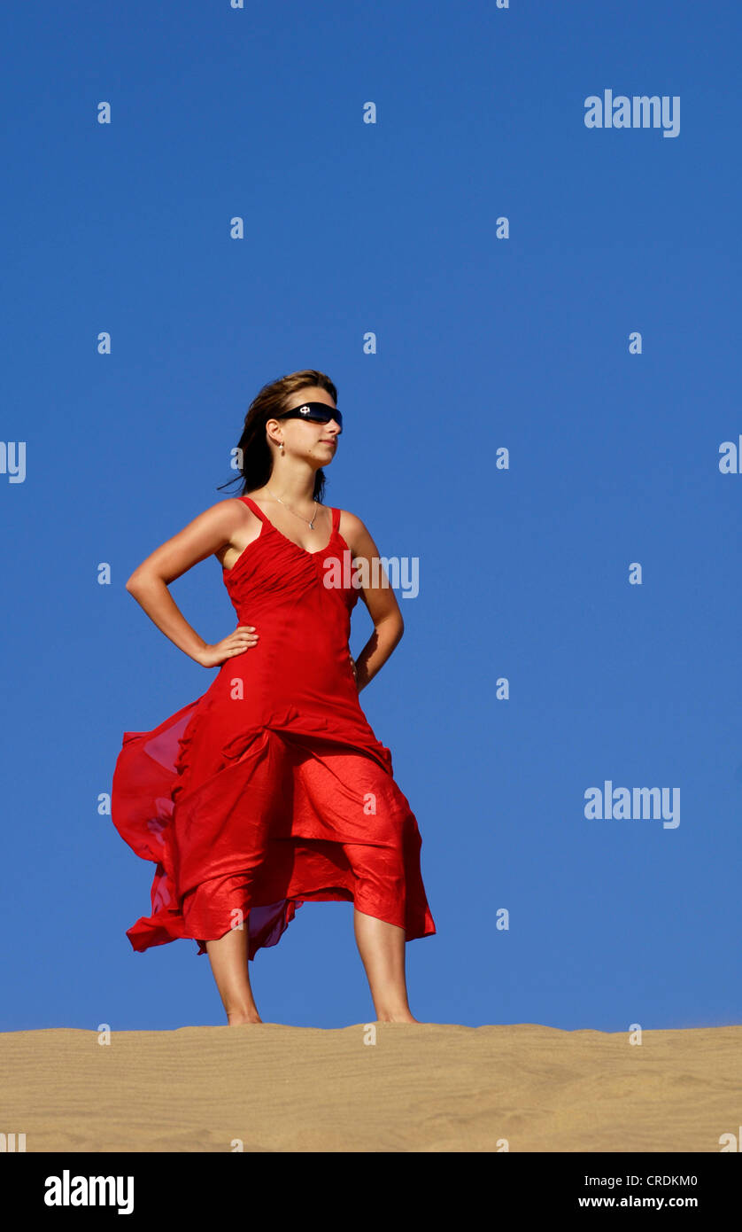 young woman standing in sand, with her hands on hips Stock Photo - Alamy