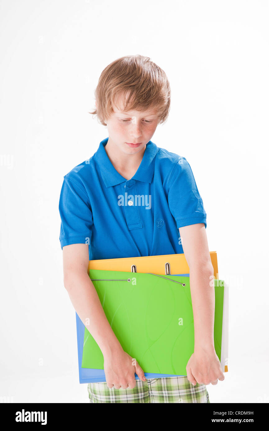 Sad teenage boy with school folders Stock Photo - Alamy