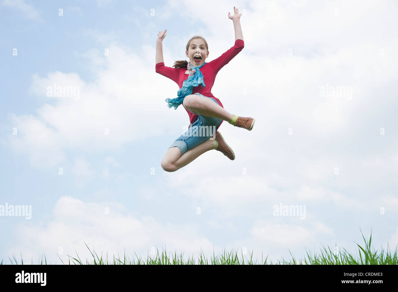 Young girl jumping into the air Stock Photo - Alamy