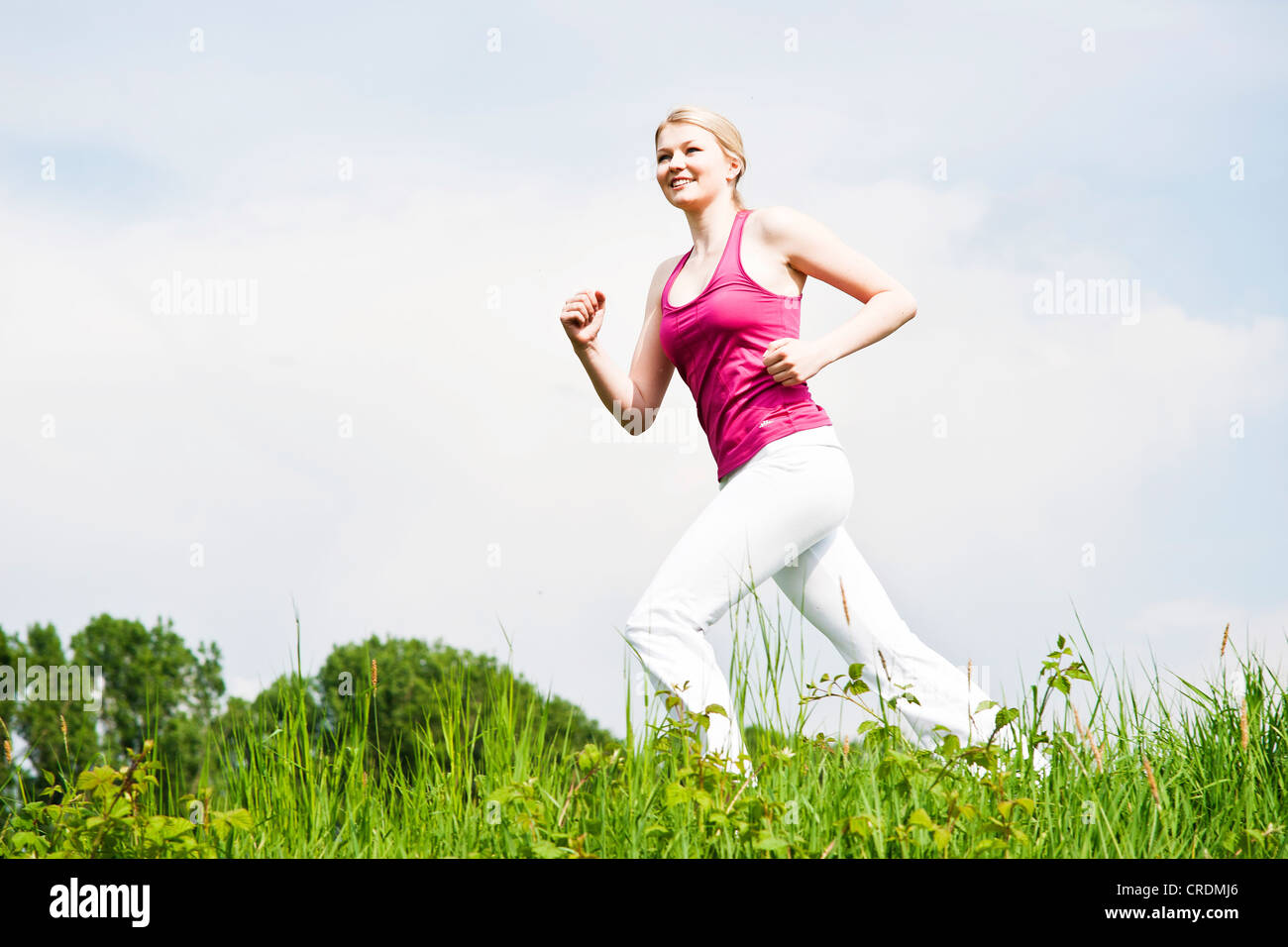 Young woman jogging Stock Photo - Alamy