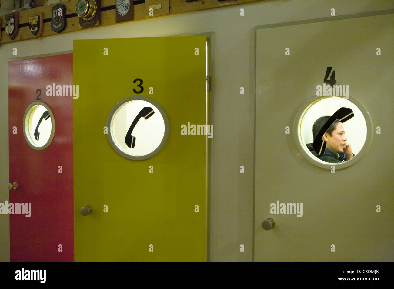 Sailor making a phone call home from a telephone booth, Seemannsclub ...