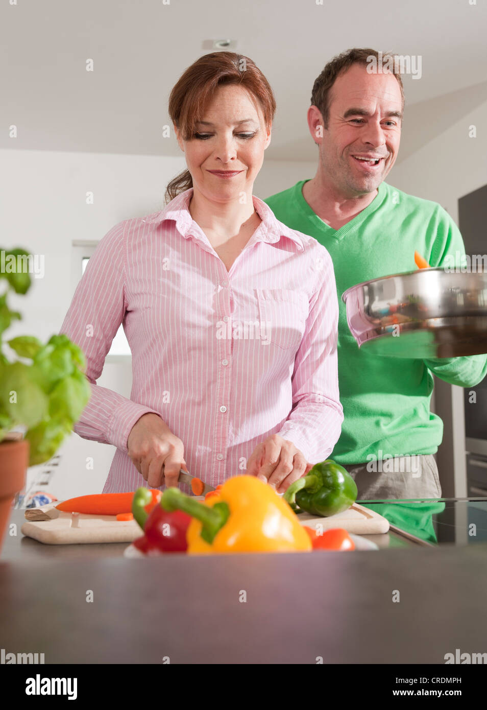A man and a woman cooking together Stock Photo - Alamy