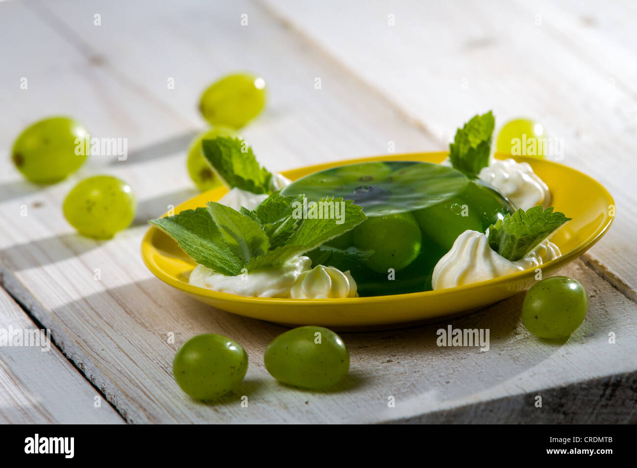 Green dessert served with fruit Stock Photo - Alamy