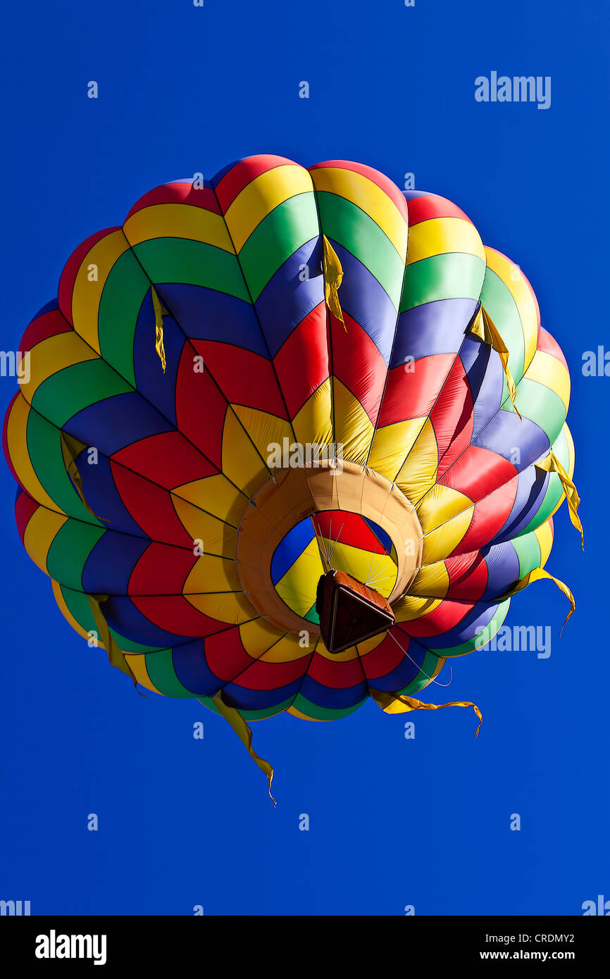 Colorful hot air balloon rising into the deep blue sky Stock Photo - Alamy