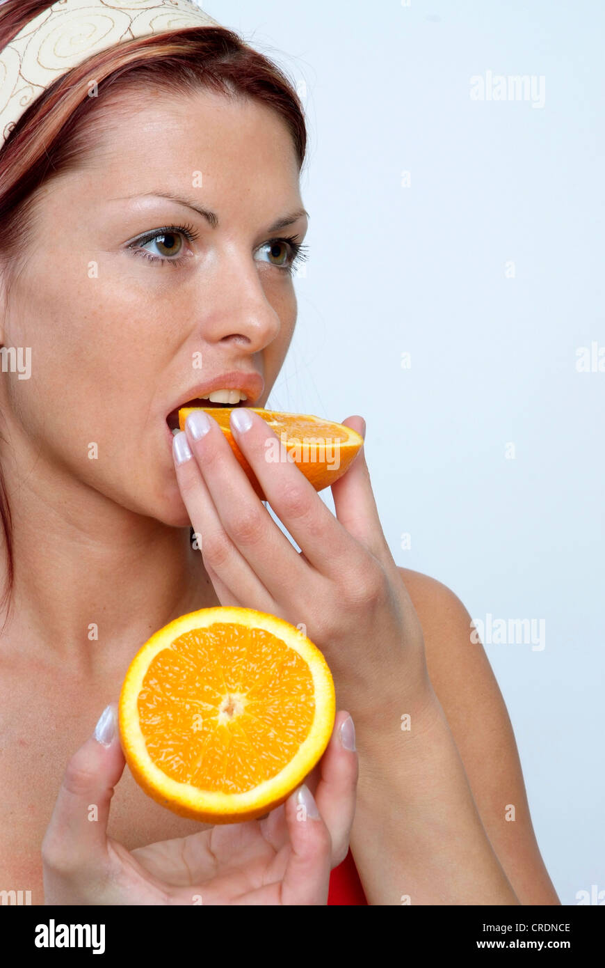 young woman eating an orange Stock Photo - Alamy