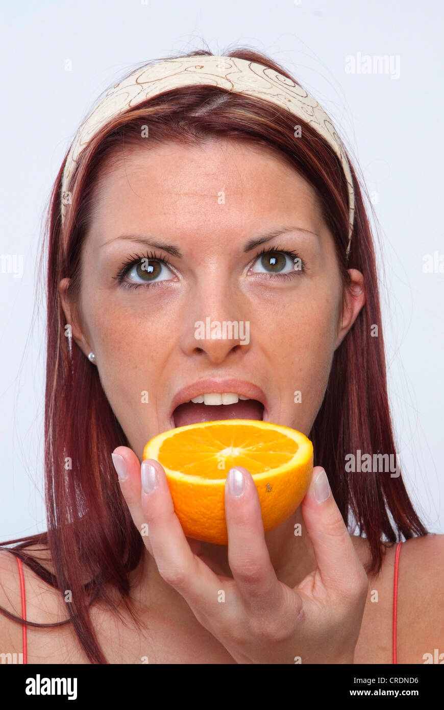 young woman eating an orange Stock Photo - Alamy