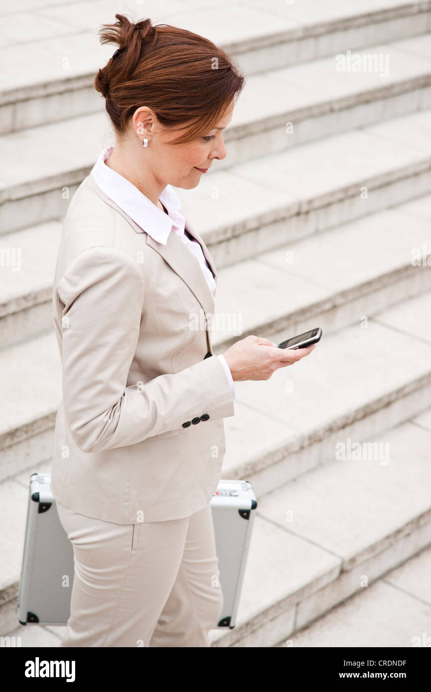 Businesswoman using a mobile phone Stock Photo - Alamy