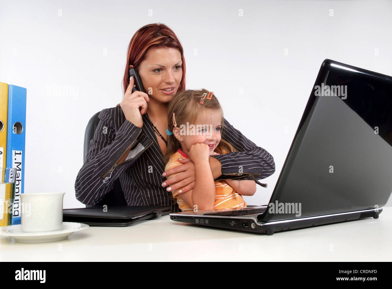 mother with child at work Stock Photo - Alamy