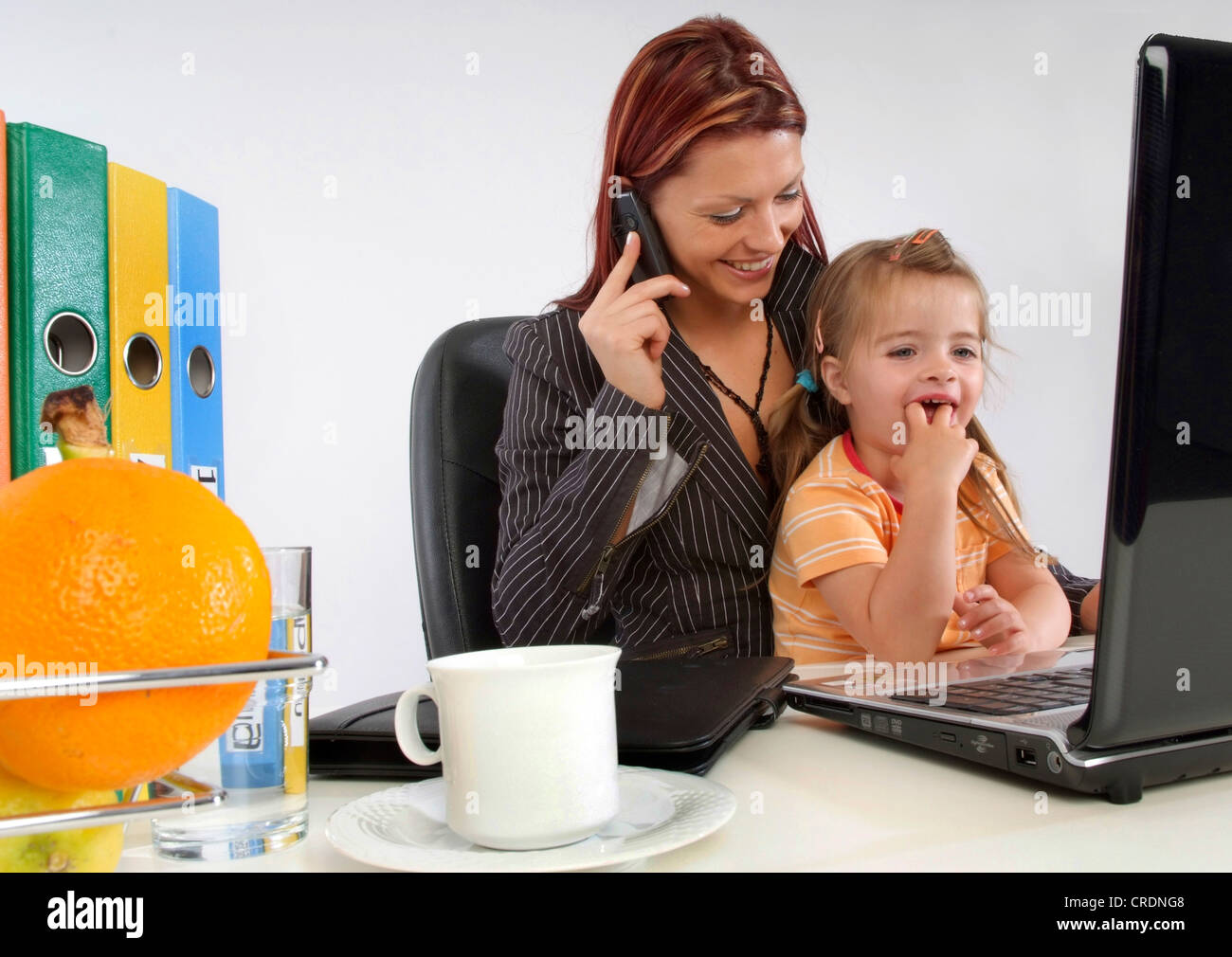 mother with child at work Stock Photo - Alamy