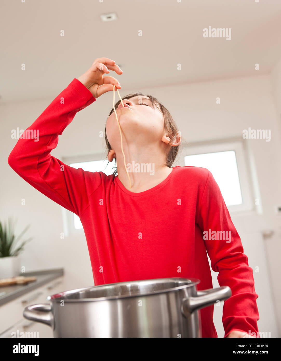 Girls tasting pasta Stock Photo - Alamy