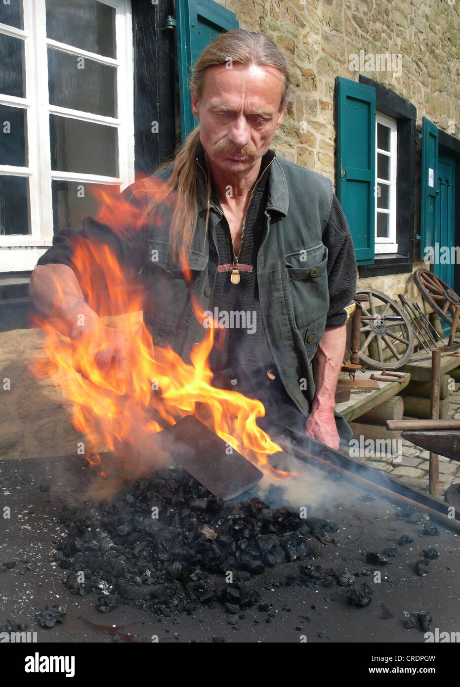 traditional handcraft, smith at work start a fire, Germany Stock Photo ...