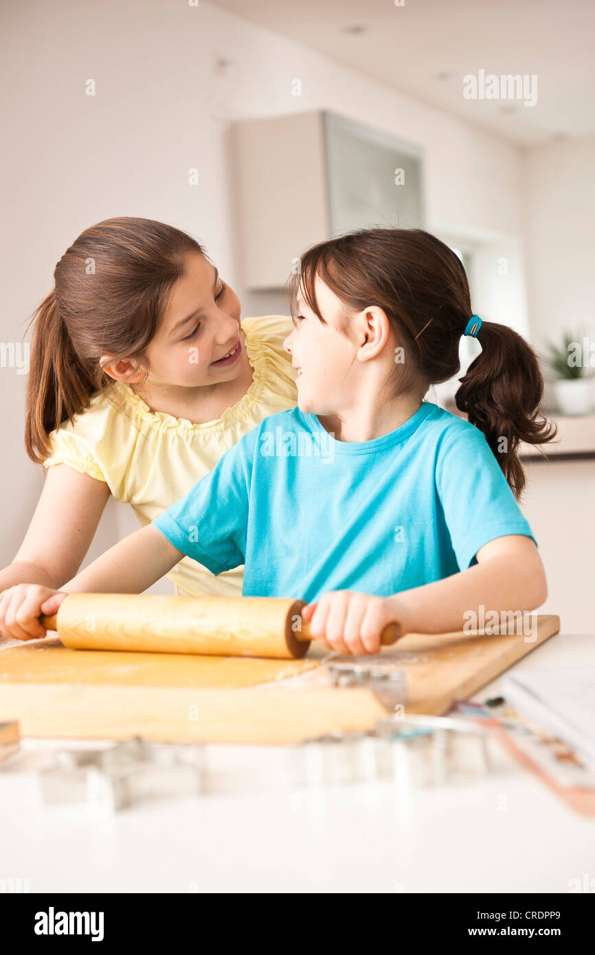 Two girls baking Christmas cookies Stock Photo - Alamy