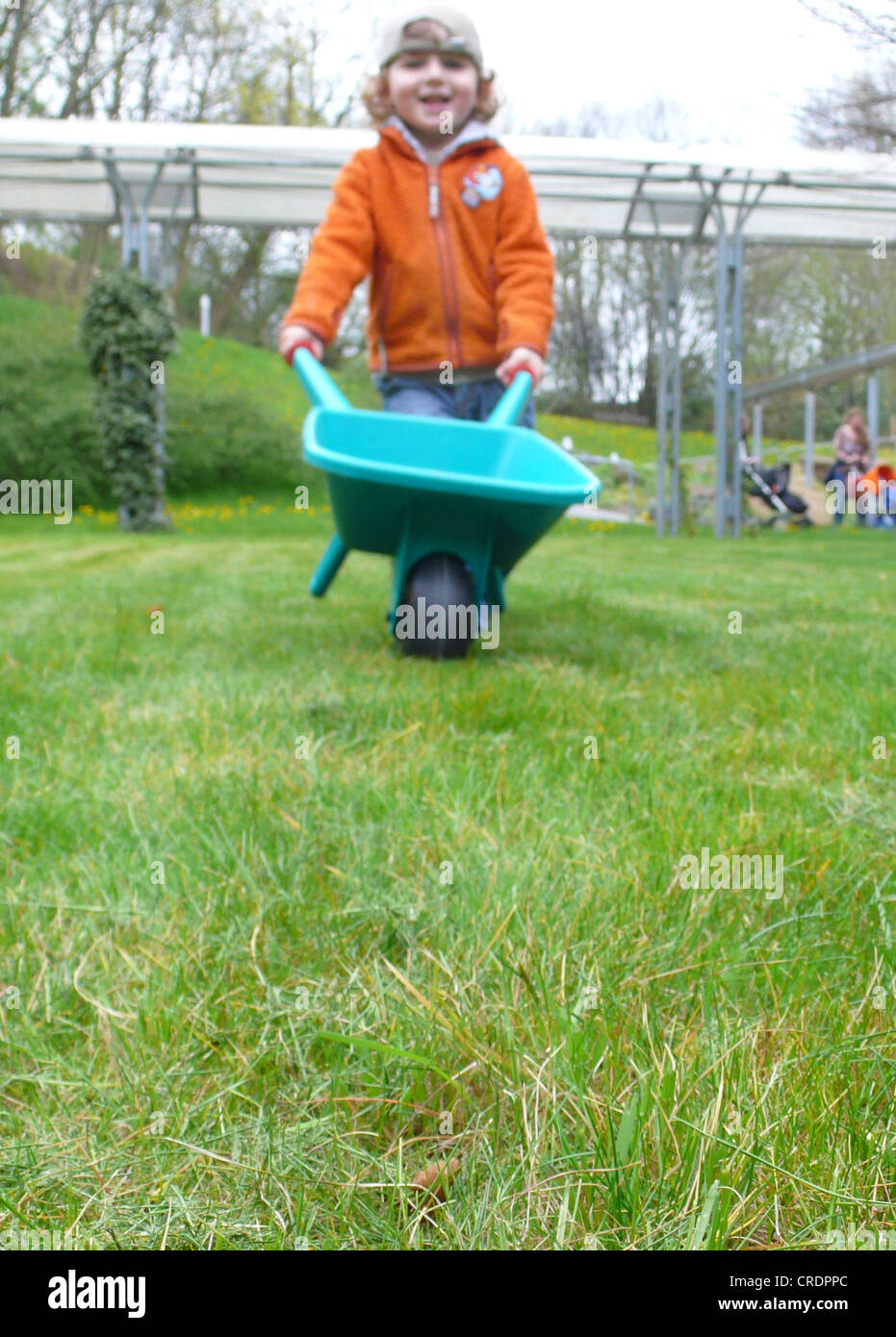 Children pushing wheelbarrows hi-res stock photography and images - Alamy