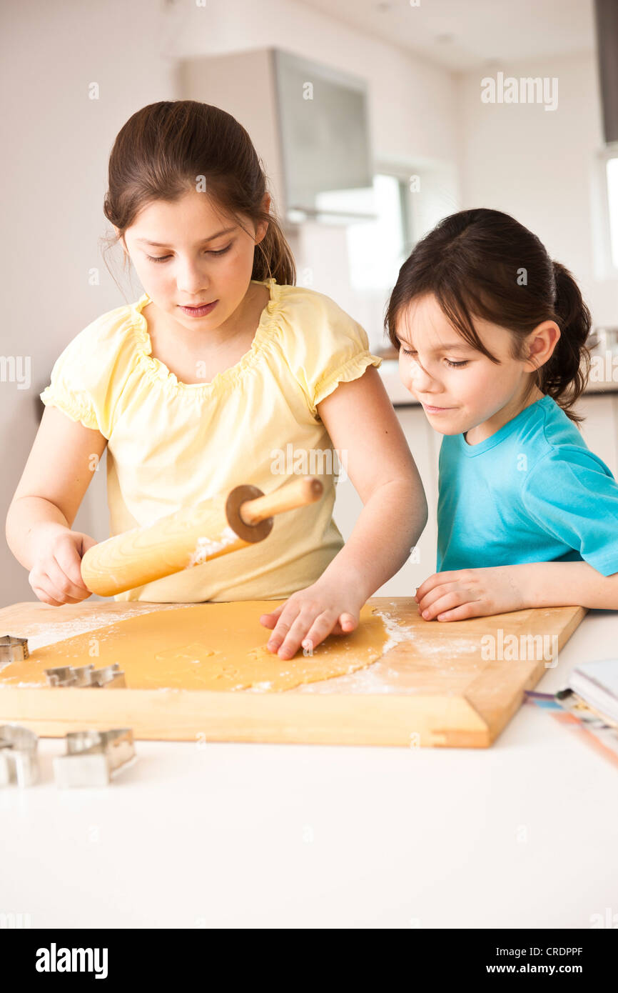 Two girls baking Christmas cookies Stock Photo - Alamy