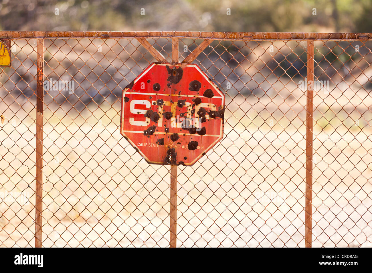 Rusty stop sign with bullet holes Stock Photo - Alamy