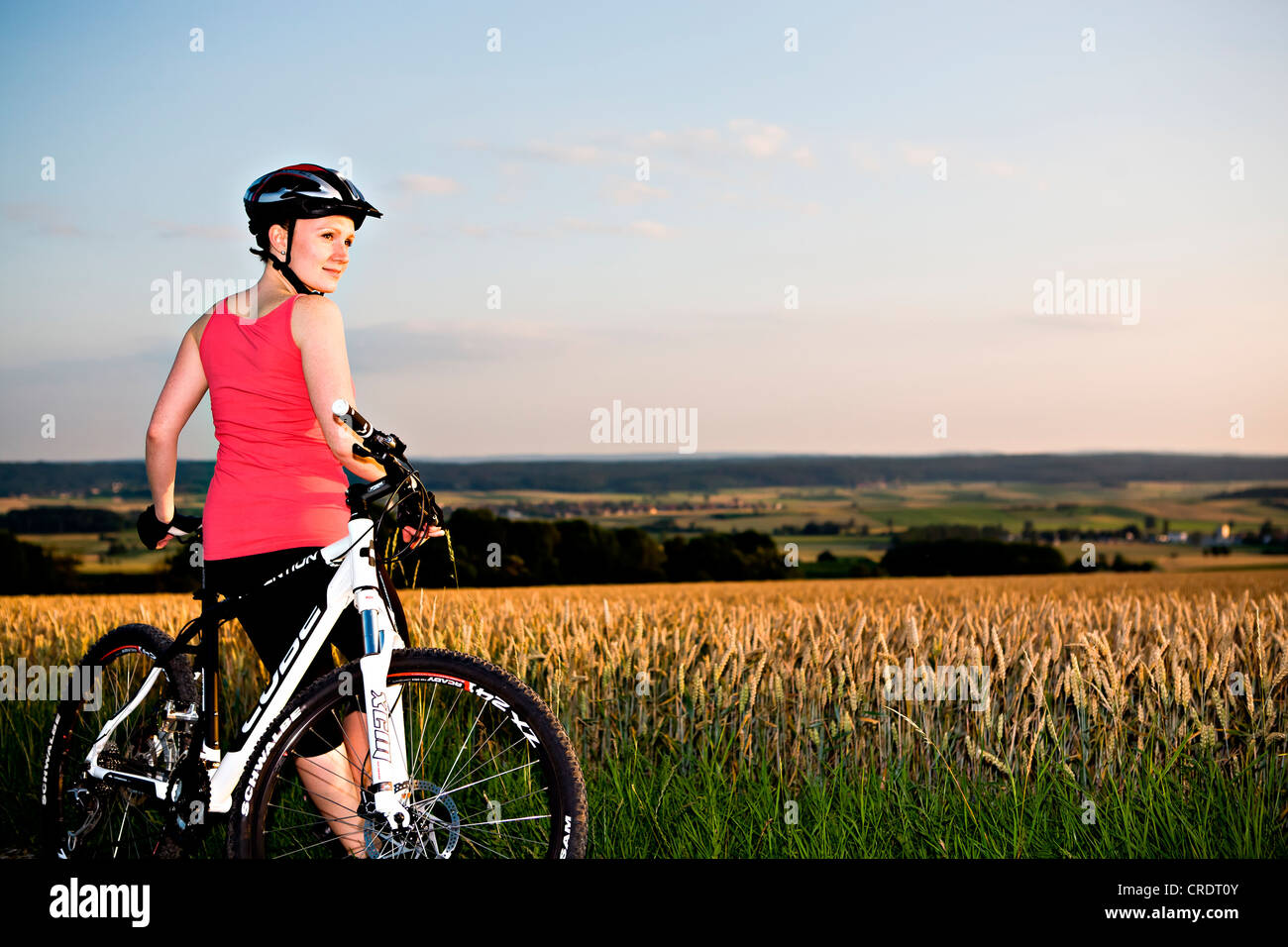 Female cyclist in rural landscape Stock Photo - Alamy