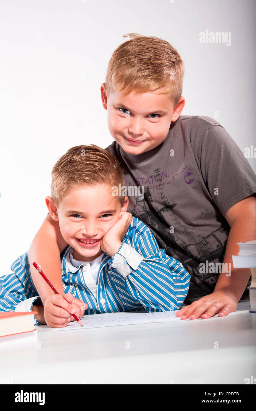 Child helps younger child hi-res stock photography and images - Alamy