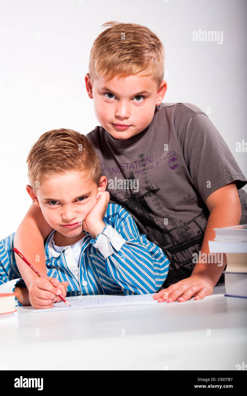 Boy helping his younger brother with his homework Stock Photo - Alamy