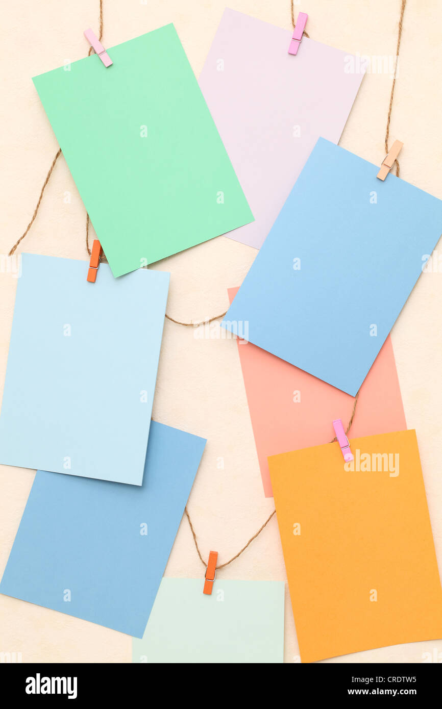 Hanging colorful paper with clothespins Stock Photo - Alamy