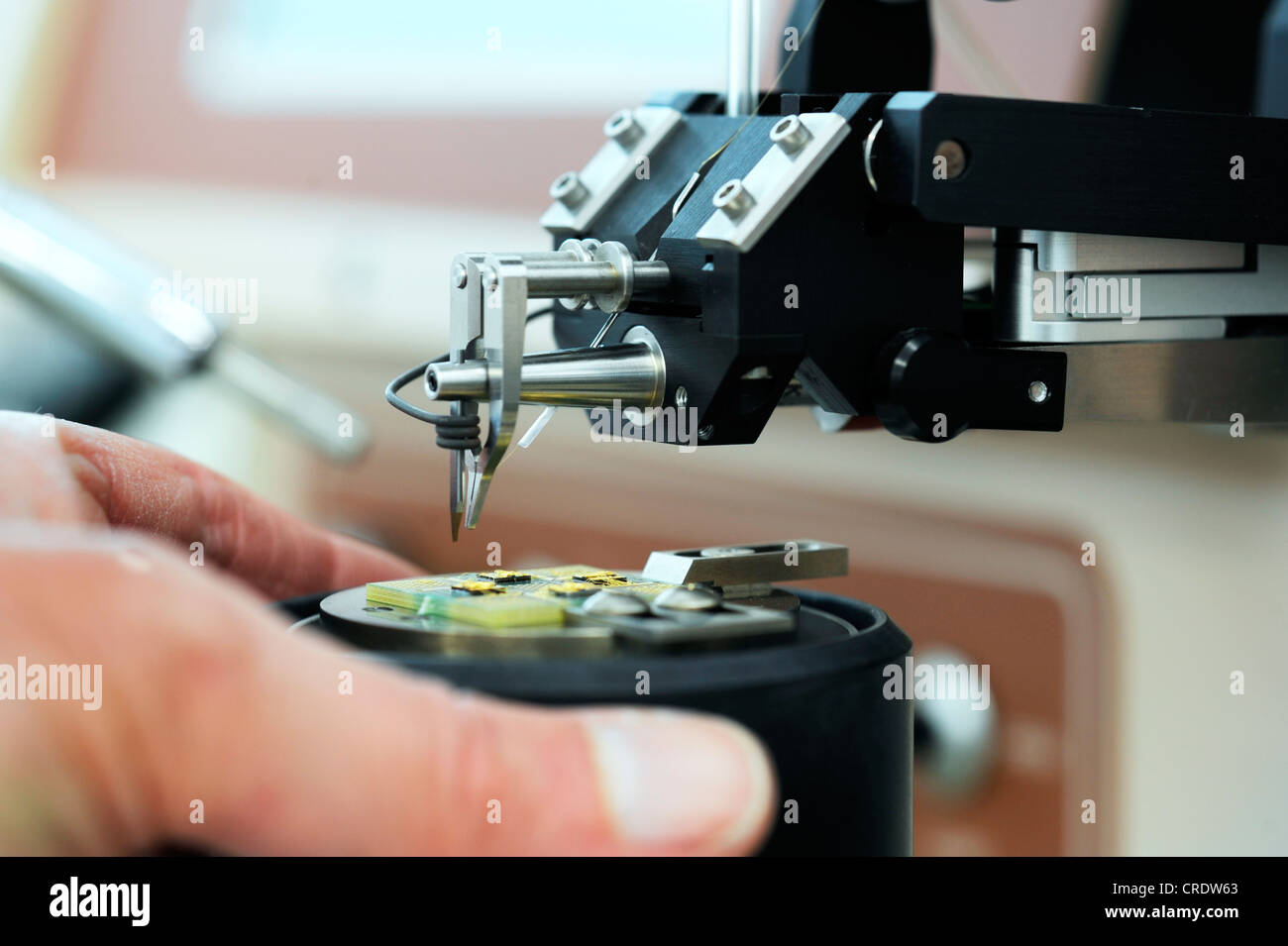 Technician adjusting a device to carry out a physical experiment Stock ...
