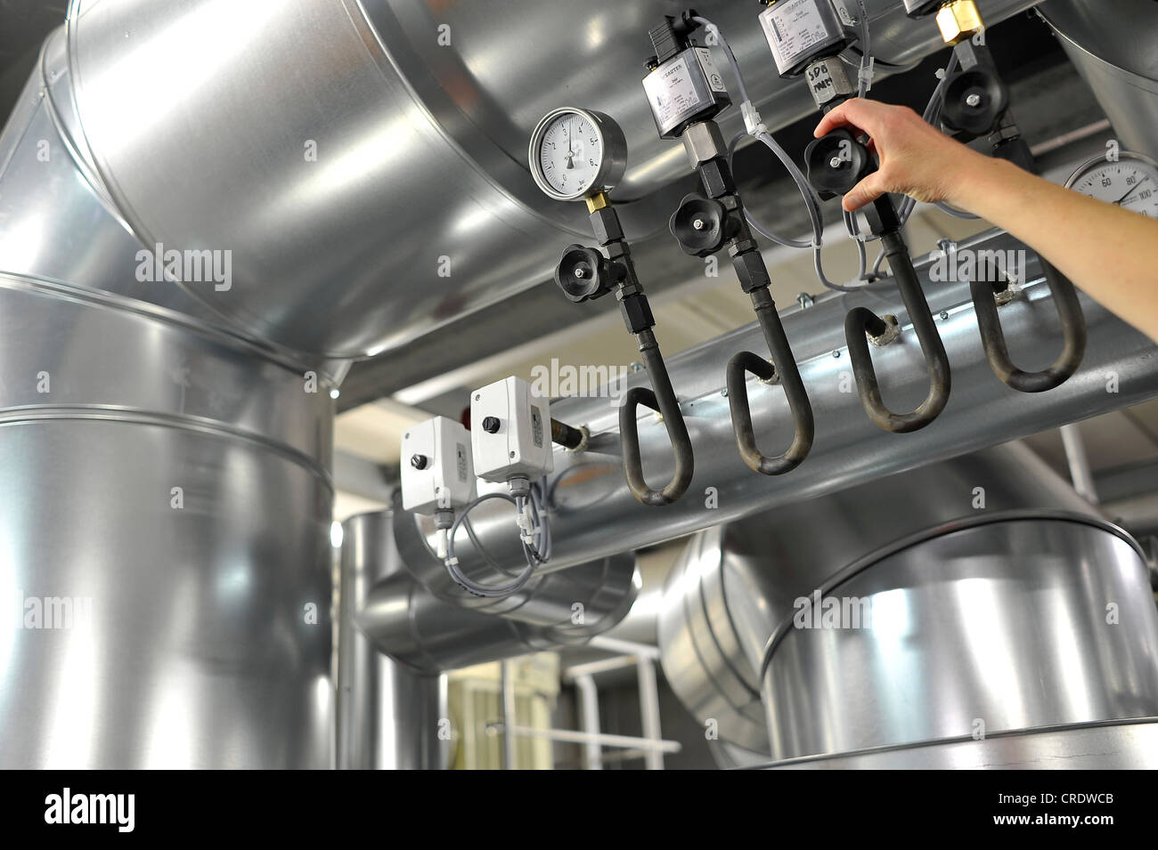 Checking a valve in a block heating station Stock Photo - Alamy