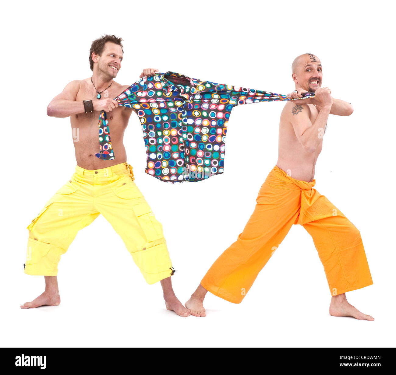 Two men pulling on a colorful shirt Stock Photo - Alamy