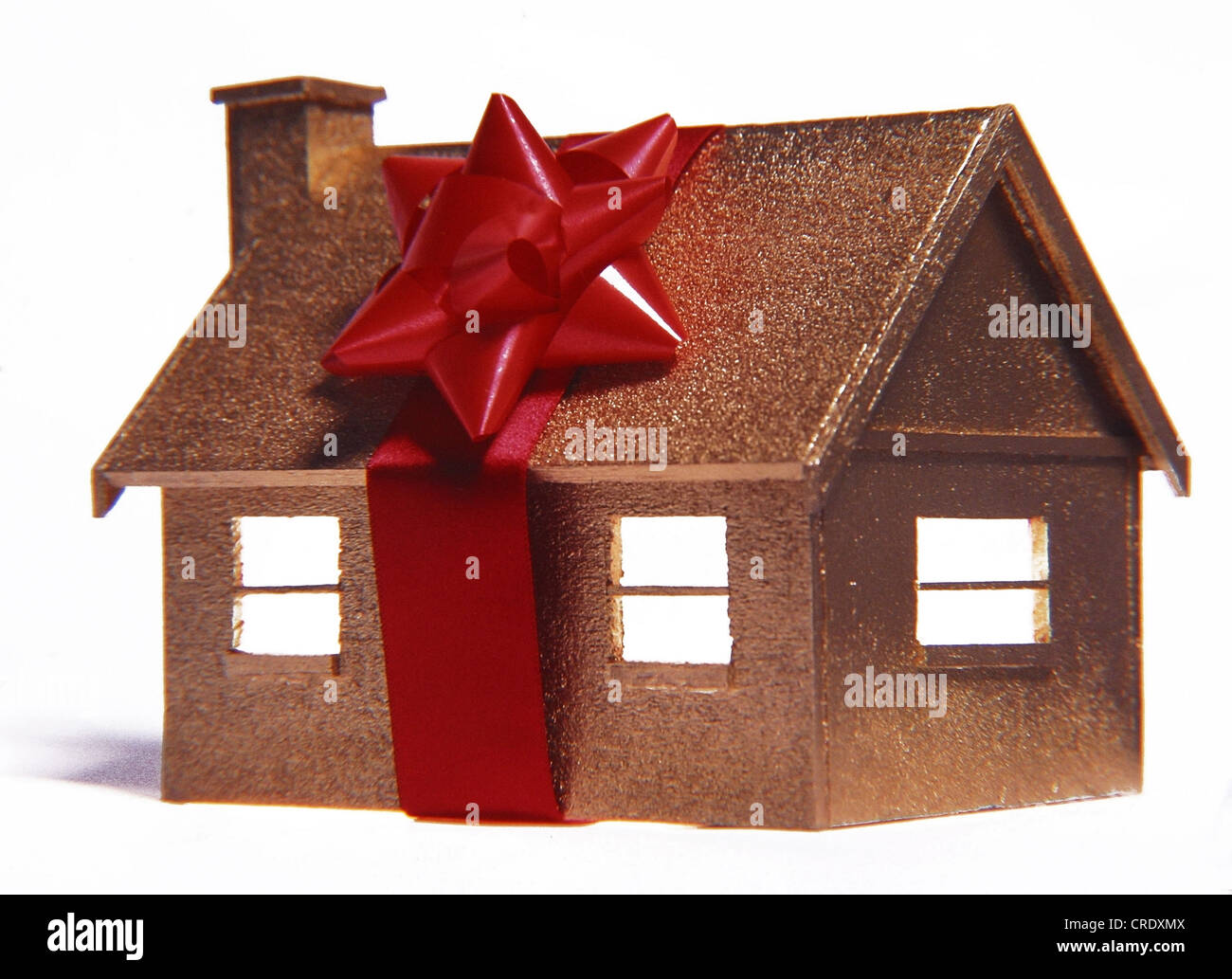 A model of a golden house with a red ribbon tied around it Stock Photo ...