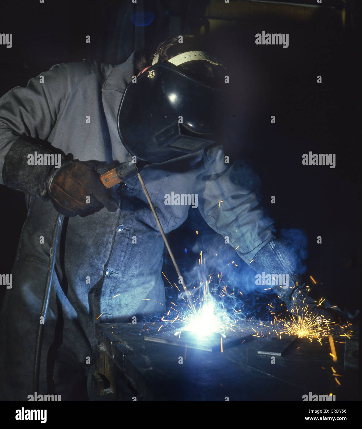 Man in safety equipment electric welding Stock Photo - Alamy