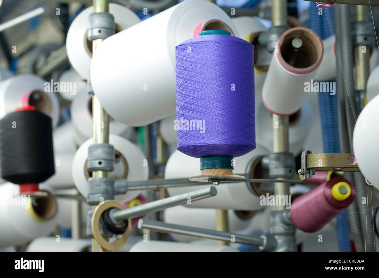 Spools of thread in a knitting machine, knitting mill, Kunert Group ...