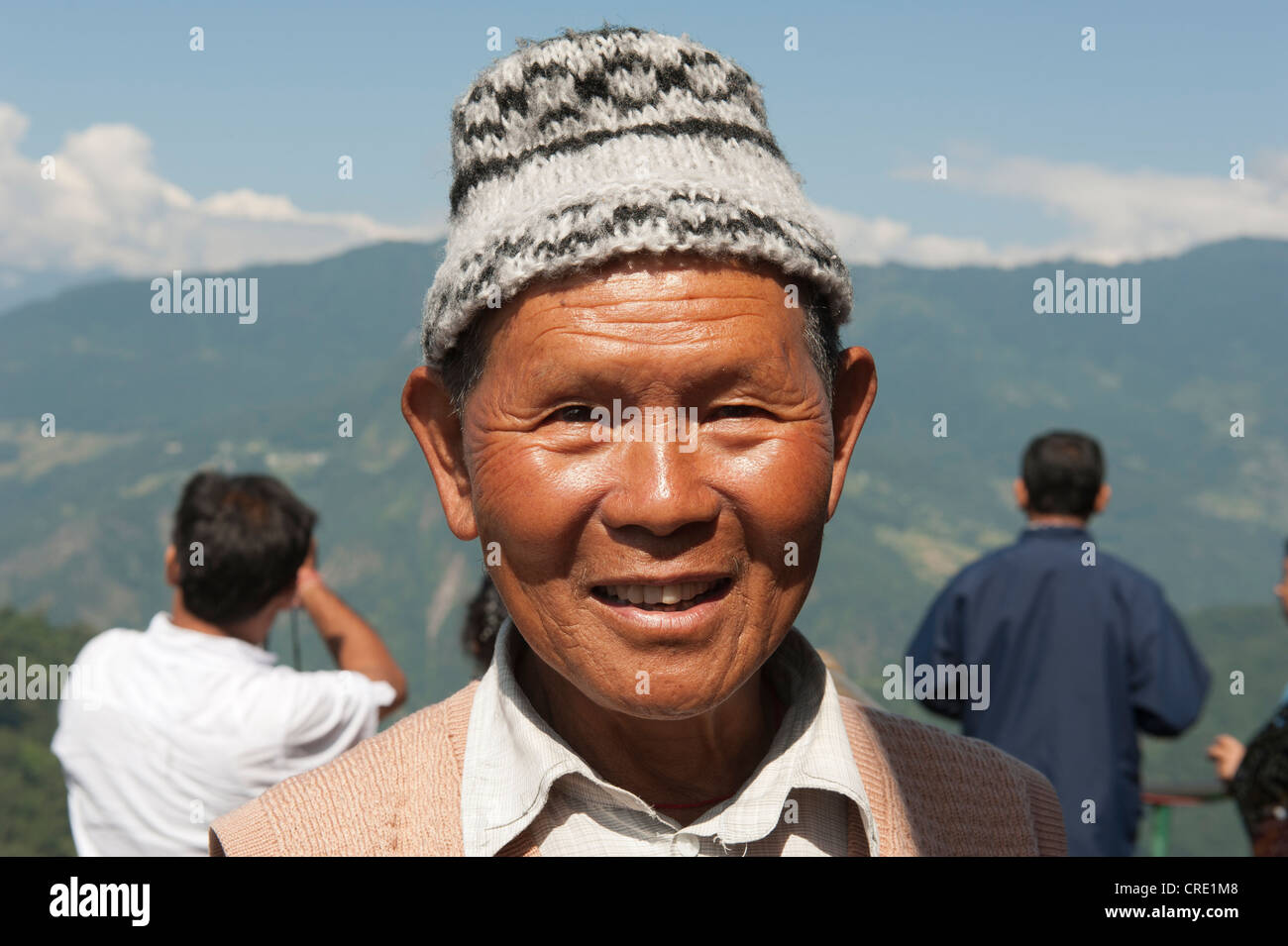 Smiling Sikkimese wearing a cap, portrait, Tashi Viewpoint, mountains ...