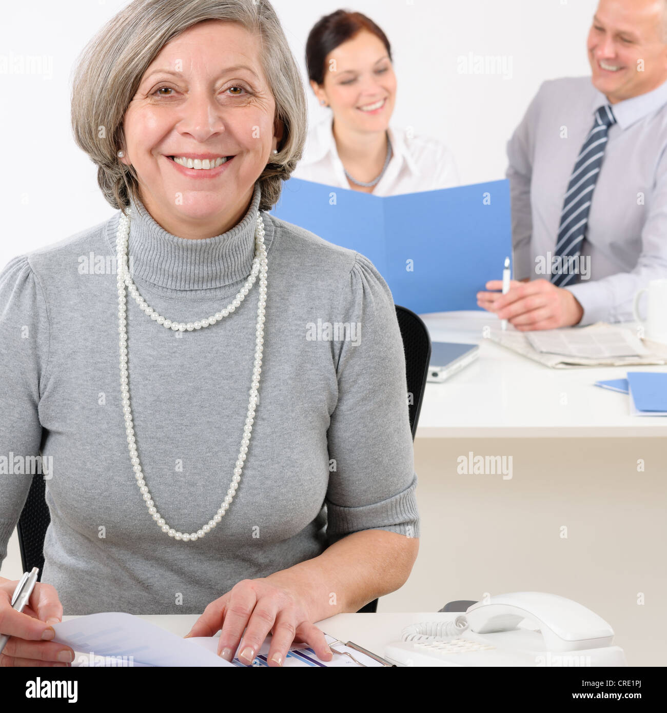 Young executive woman hold report sitting at office with colleagues ...