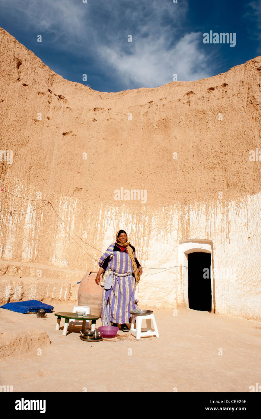 Berber woman dressed in traditional costume in a cave dwelling, Matmata ...