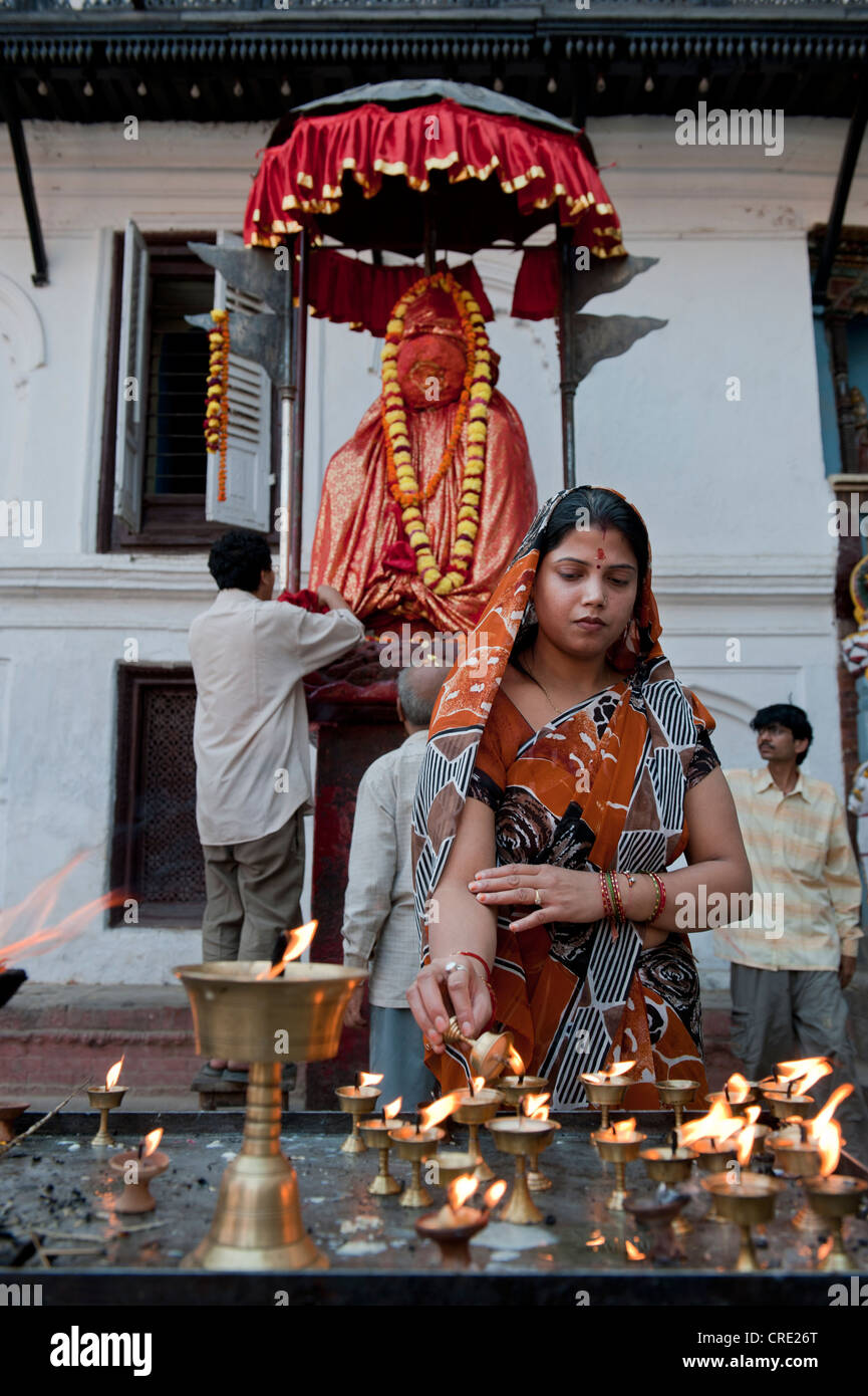 Hinduism, believers with butter lamps, Hanuman statue, square in front ...