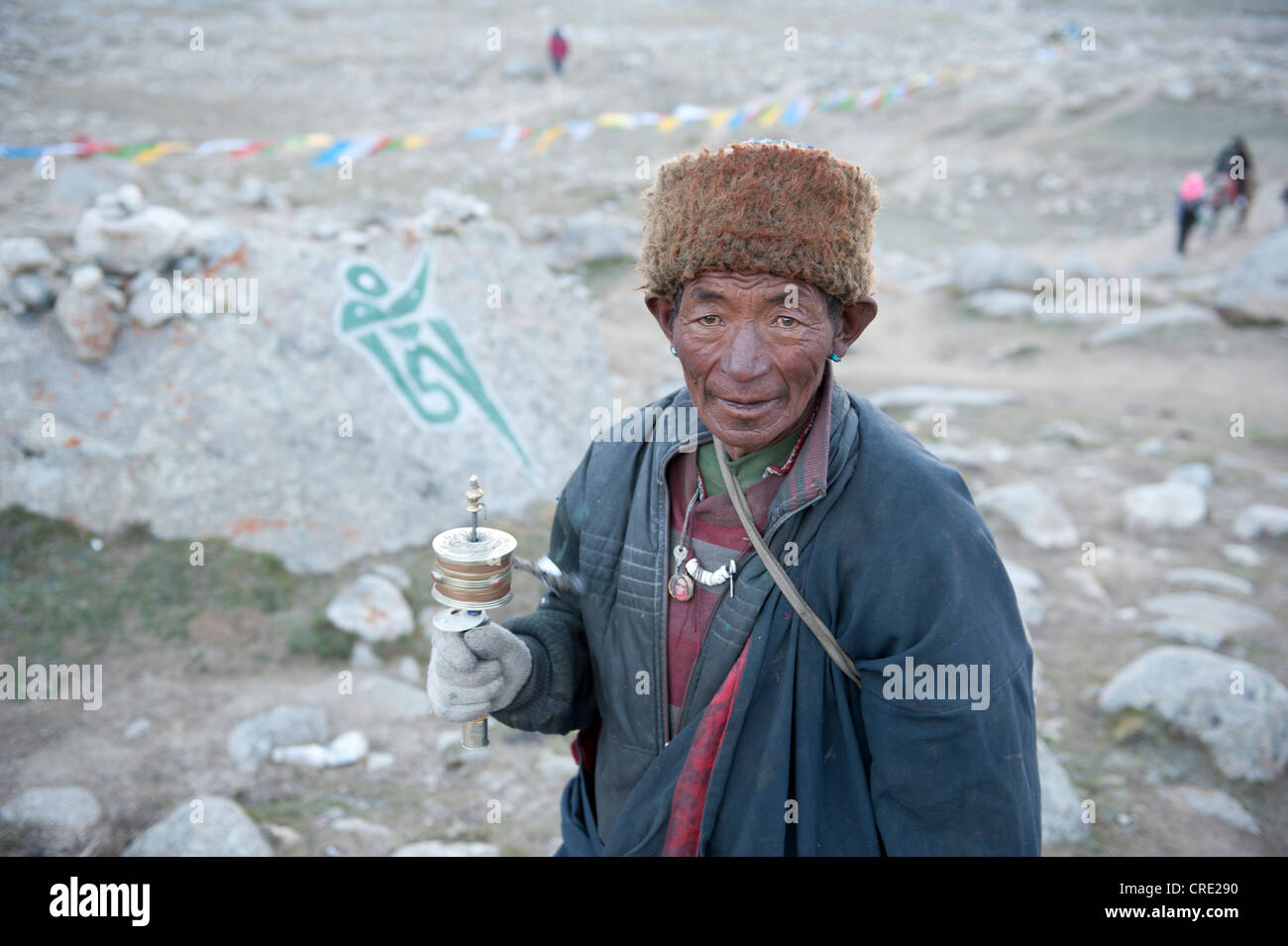 Tibetan Buddhism, Tibetan pilgrim turning a prayer wheel, Tibetan ...