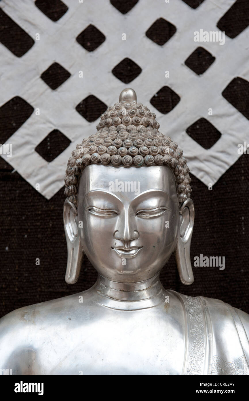 Tibetan Buddhism, silver Buddha statue, symbol of the endless knot or ...