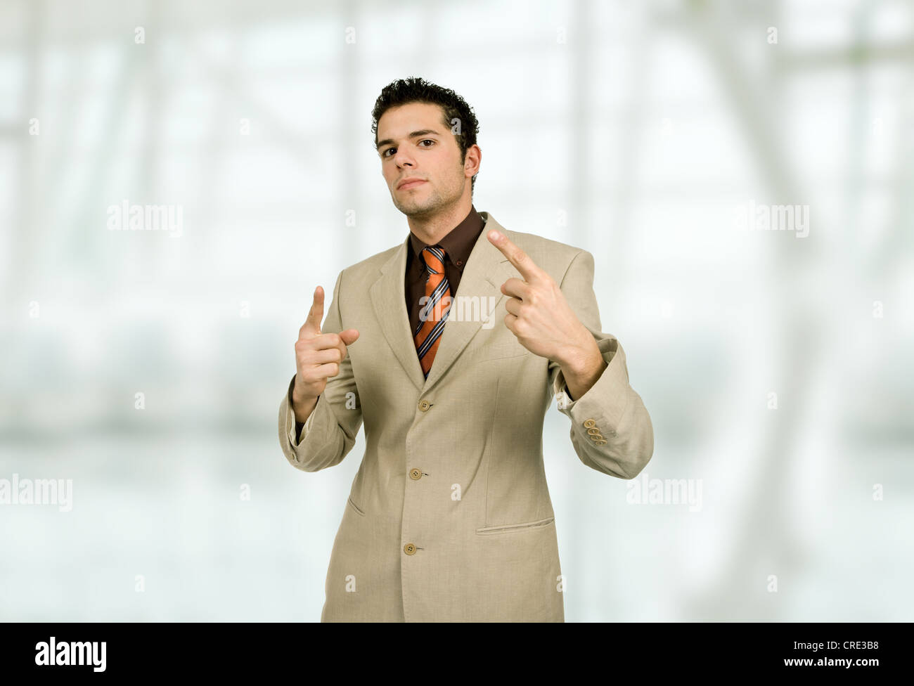 Businessman in a suit pointing up at the office Stock Photo - Alamy