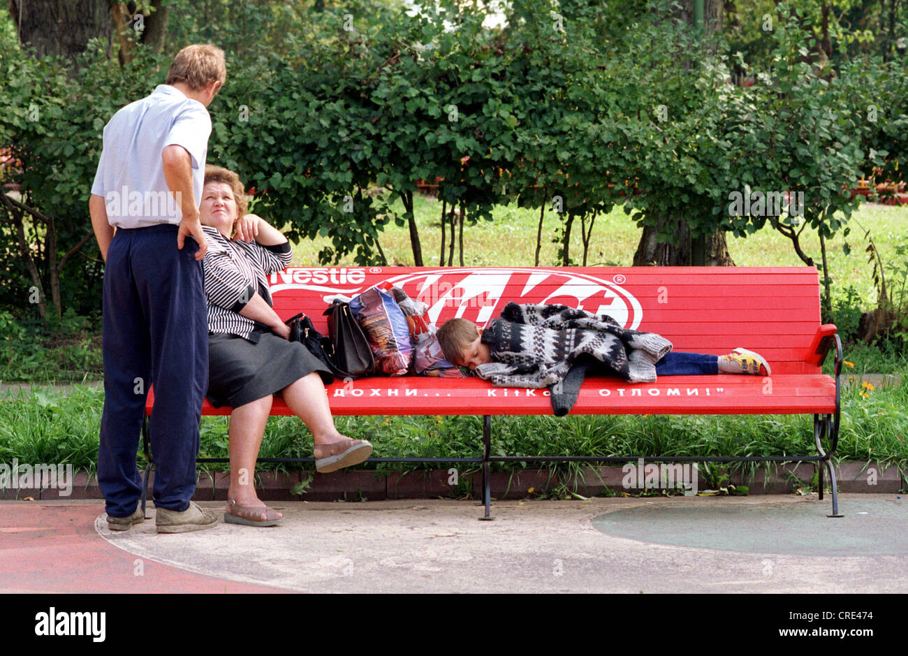 Boy is sleeping on a park bench Stock Photo - Alamy