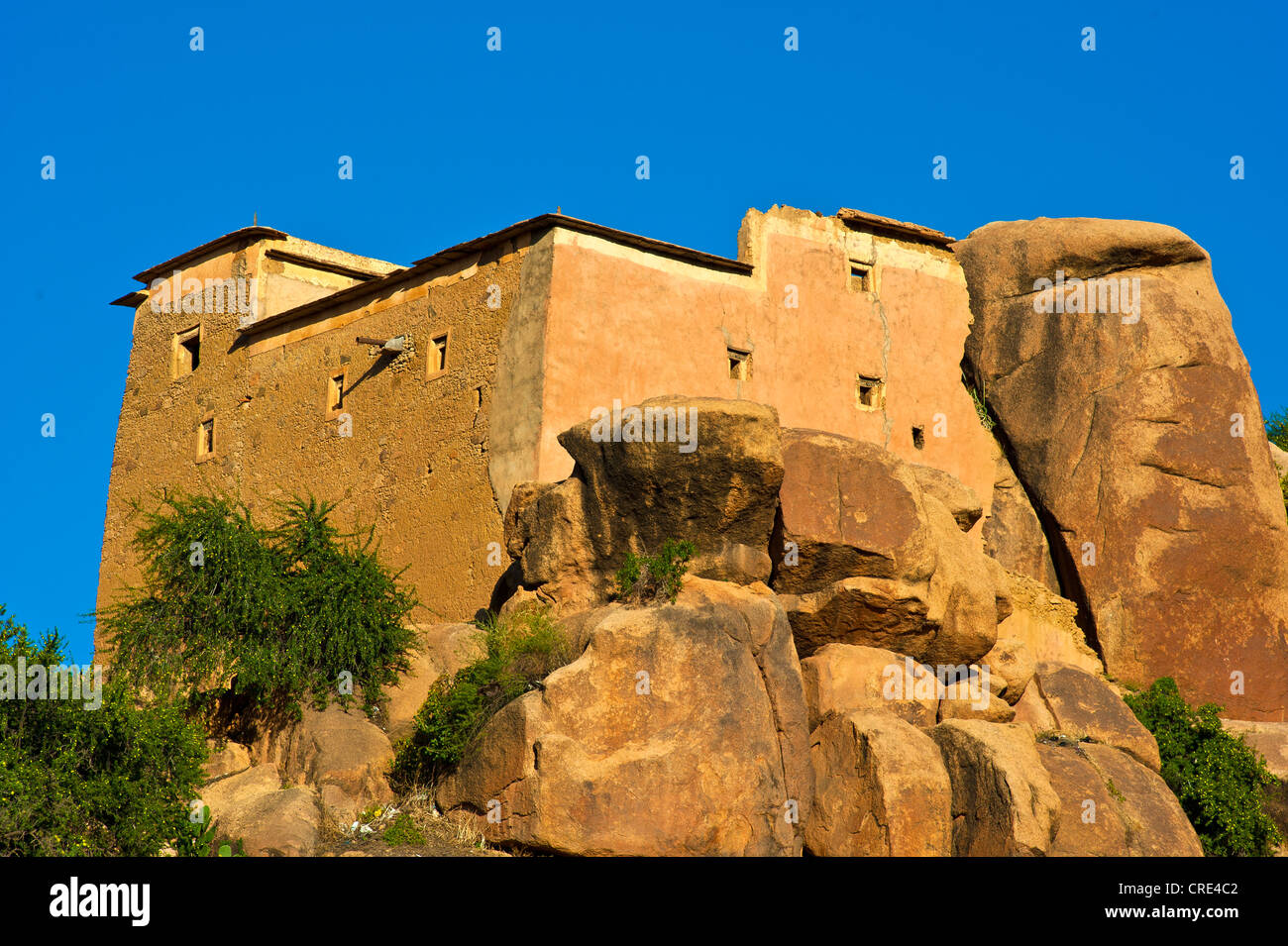 A traditional house built on a rocky outcrop between large granite ...