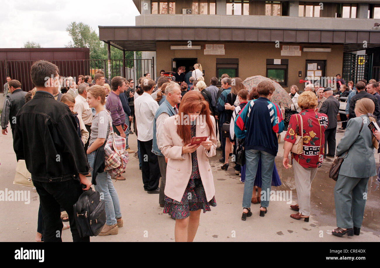 Moscow, young woman looks at passport before the visa section of the ...
