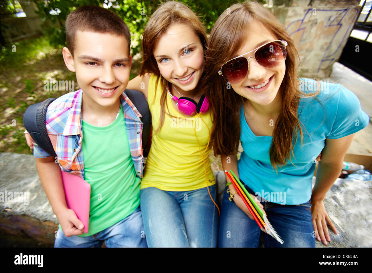 Portrait of a group of good school friends hugging in front of the cam ...