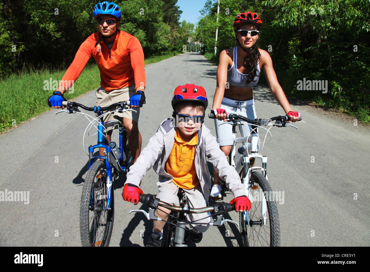 Group of cyclists following a long asphalted road Stock Photo - Alamy