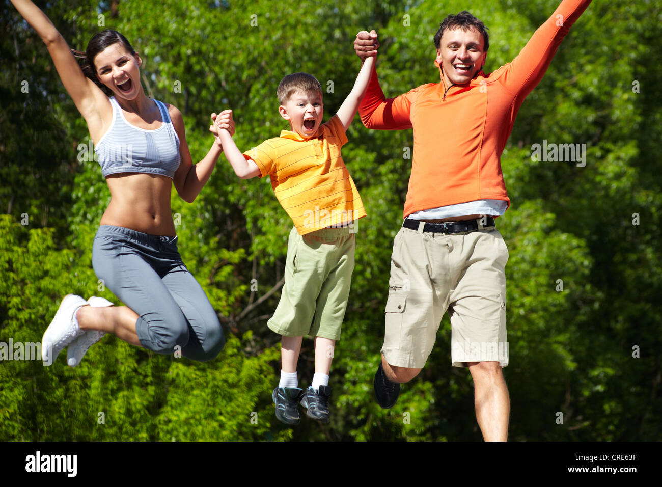 Simultaneous family jump manifesting love for life and vitality Stock ...